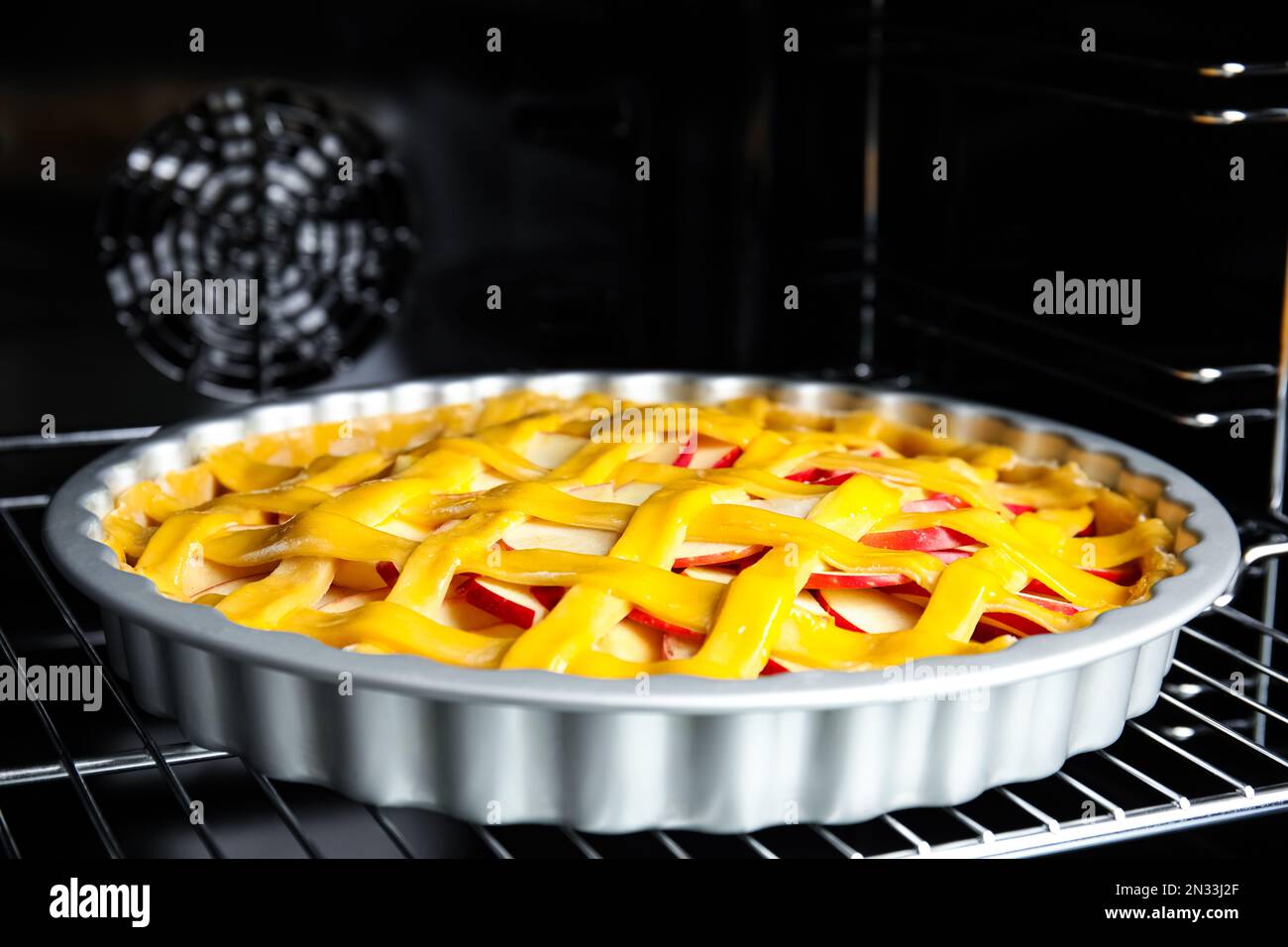 Traditional English apple pie on shelf of oven, closeup Stock Photo - Alamy