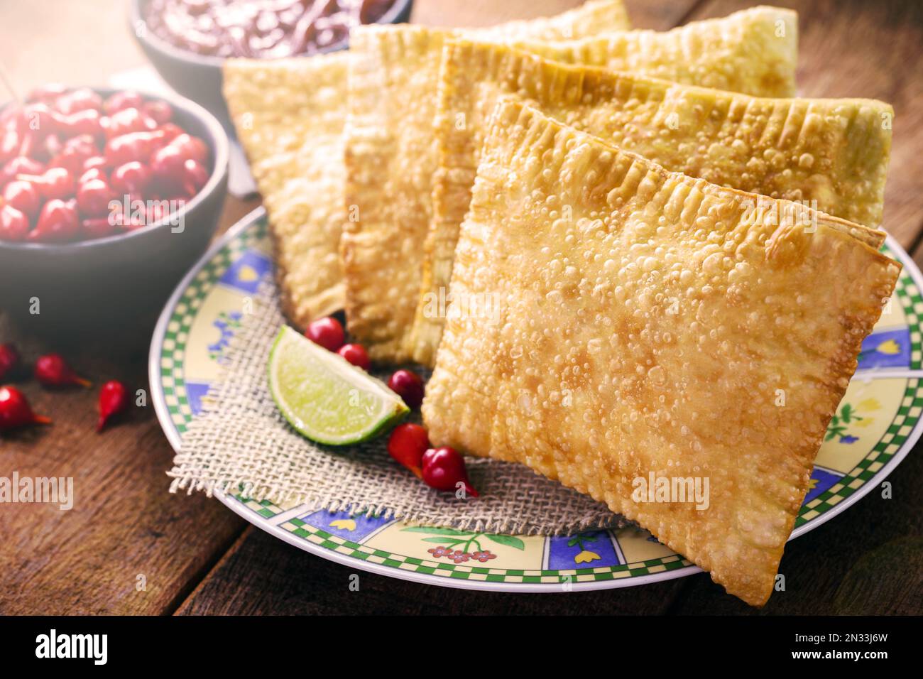 Brazilian pastry, traditional fried dough called pastel with lemon or ...