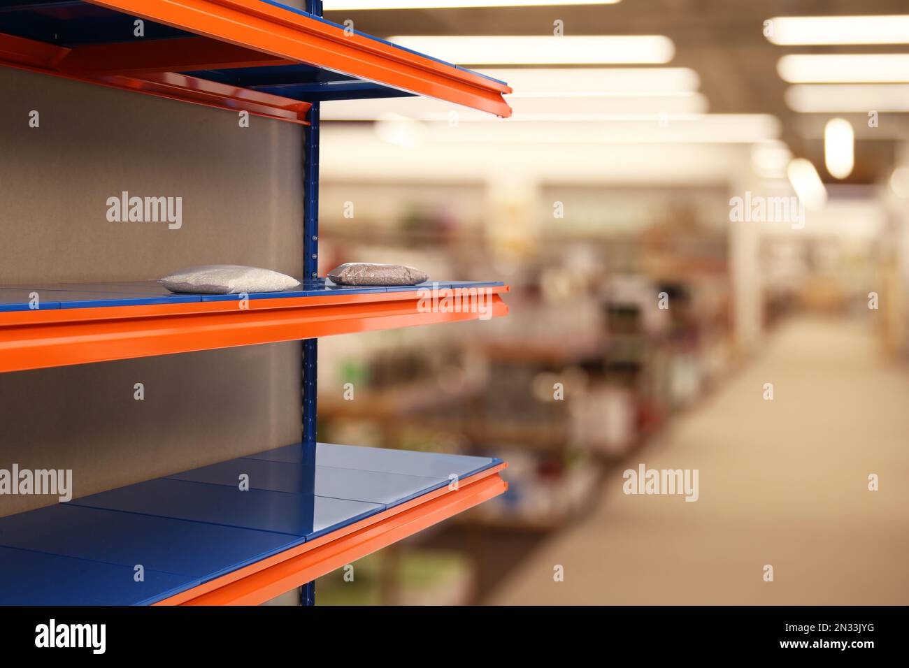 Almost empty shelves in supermarket, closeup. Product deficiency due to ...