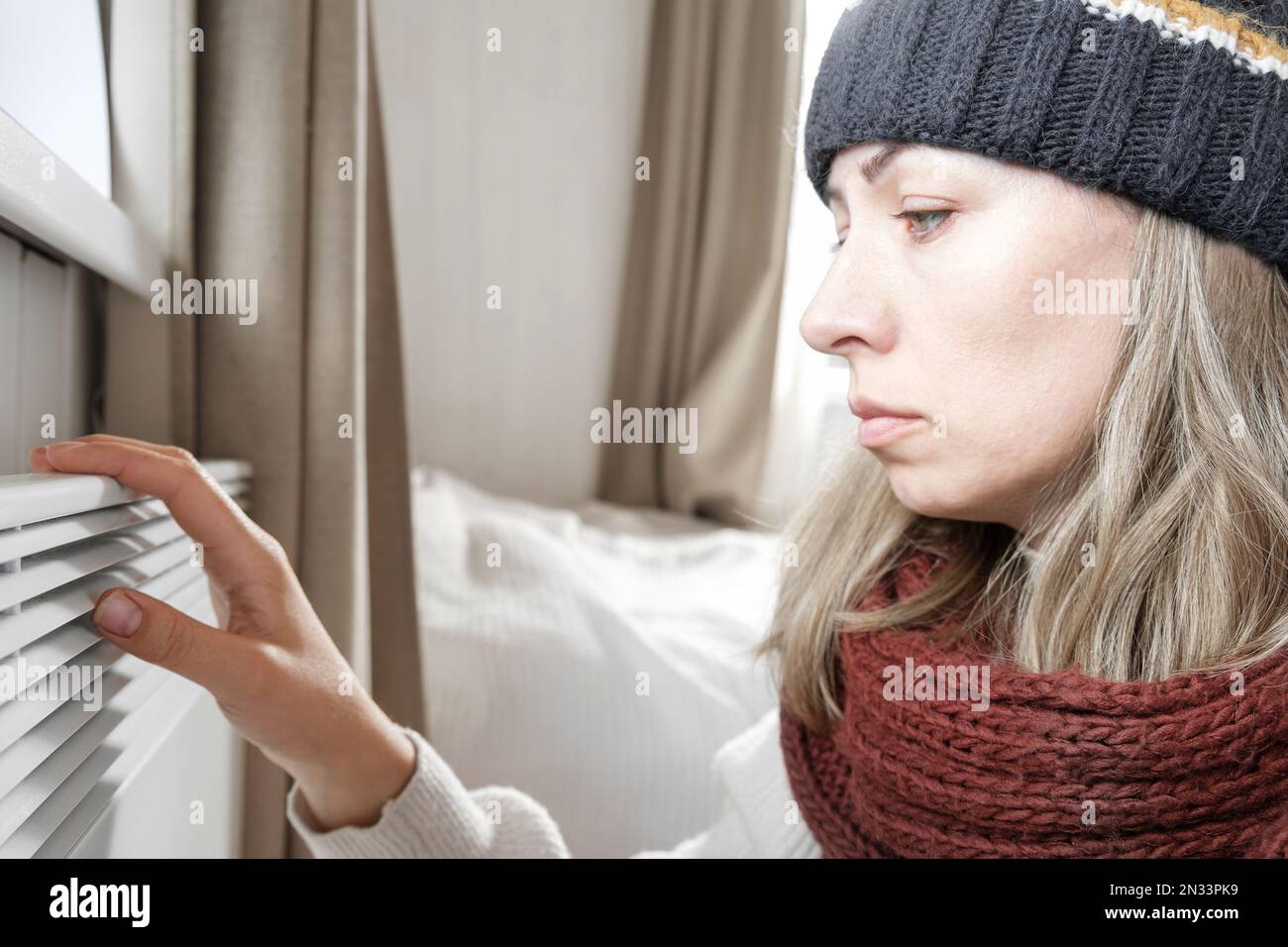 Young frozen woman wearing a sweater shaking and freezing for winter ...
