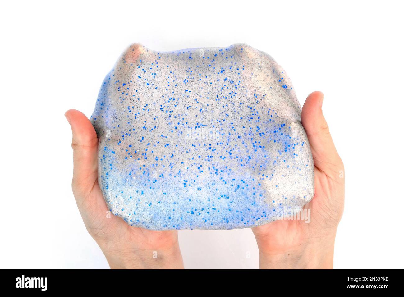 Hand Playing with textured slime on white background. Teen hand holding ...