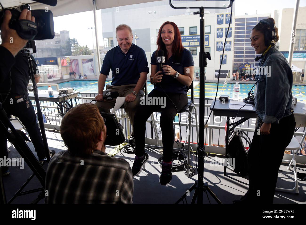 Former Olympic swimmer Amy Van Dyken, center right, begins a broadcast ...