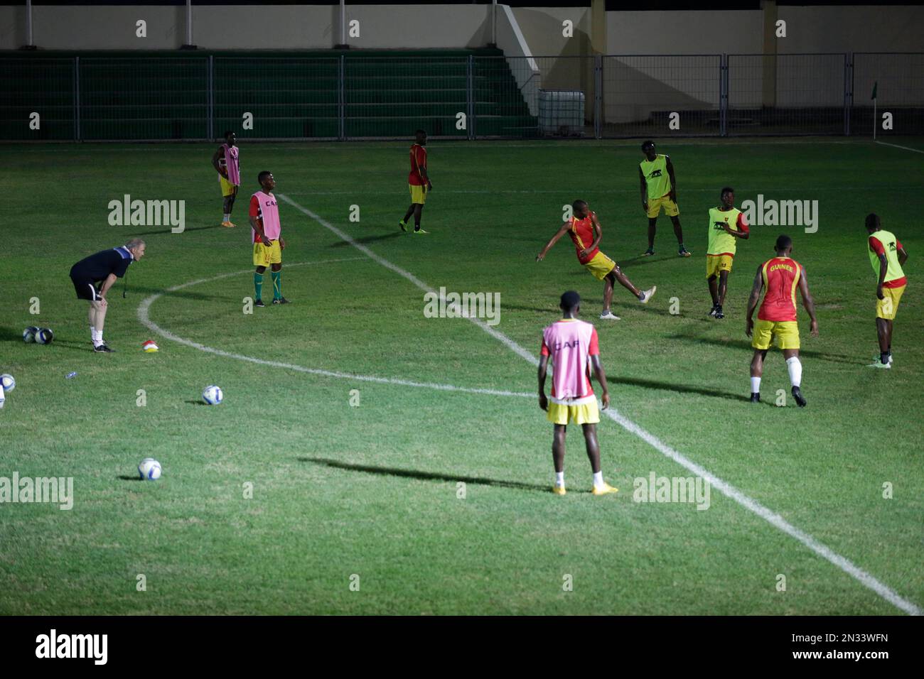 Guinea's national soccer team coach Michel Dussuyer, left, watches ...