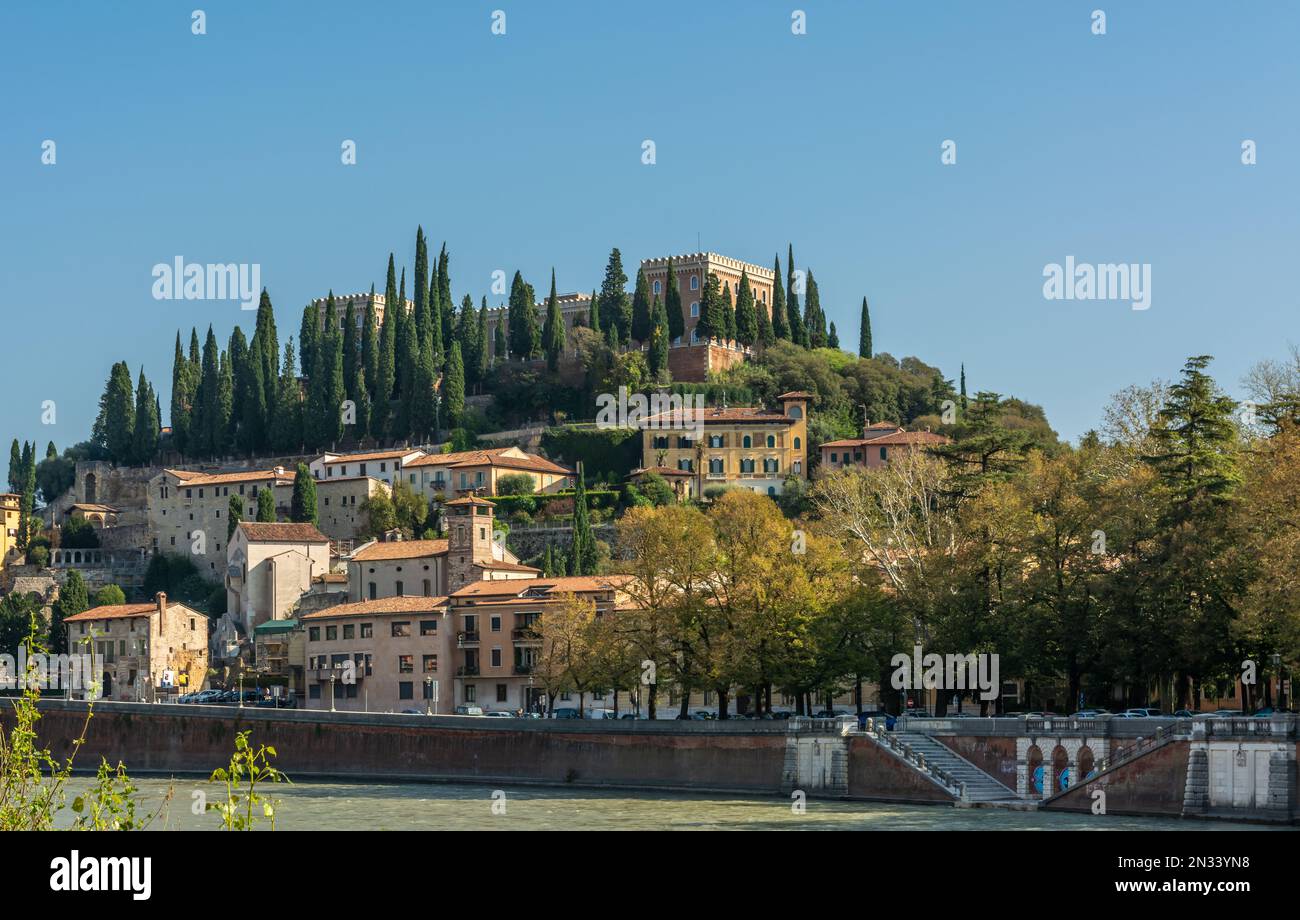 View of Castel San Pietro from the promenade along the Adige river ...