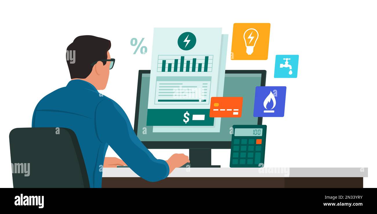 Man sitting at desk and paying his utility bills online on his computer ...