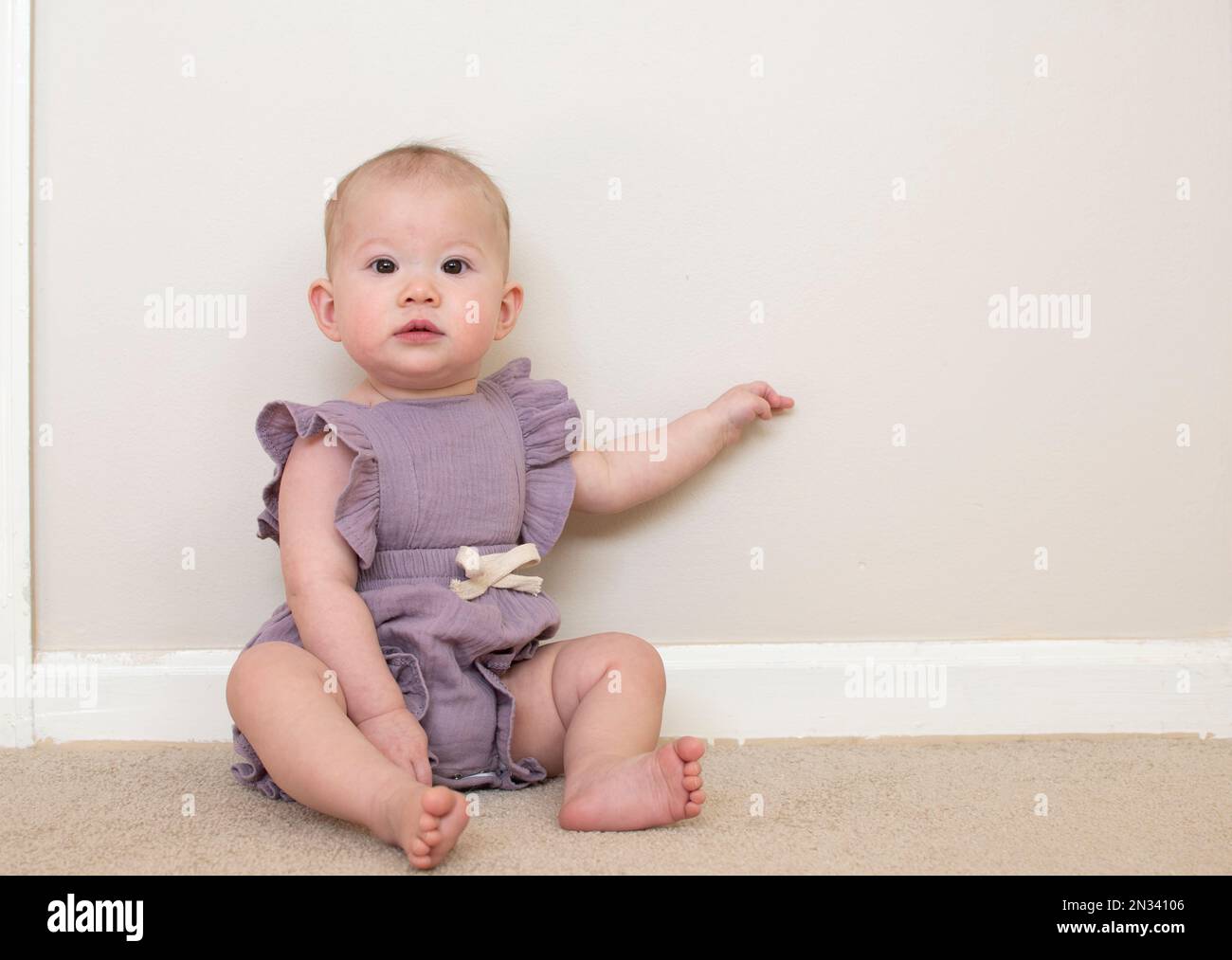 Cute caucasian baby girl learning how to sit at 9 month old Stock Photo ...