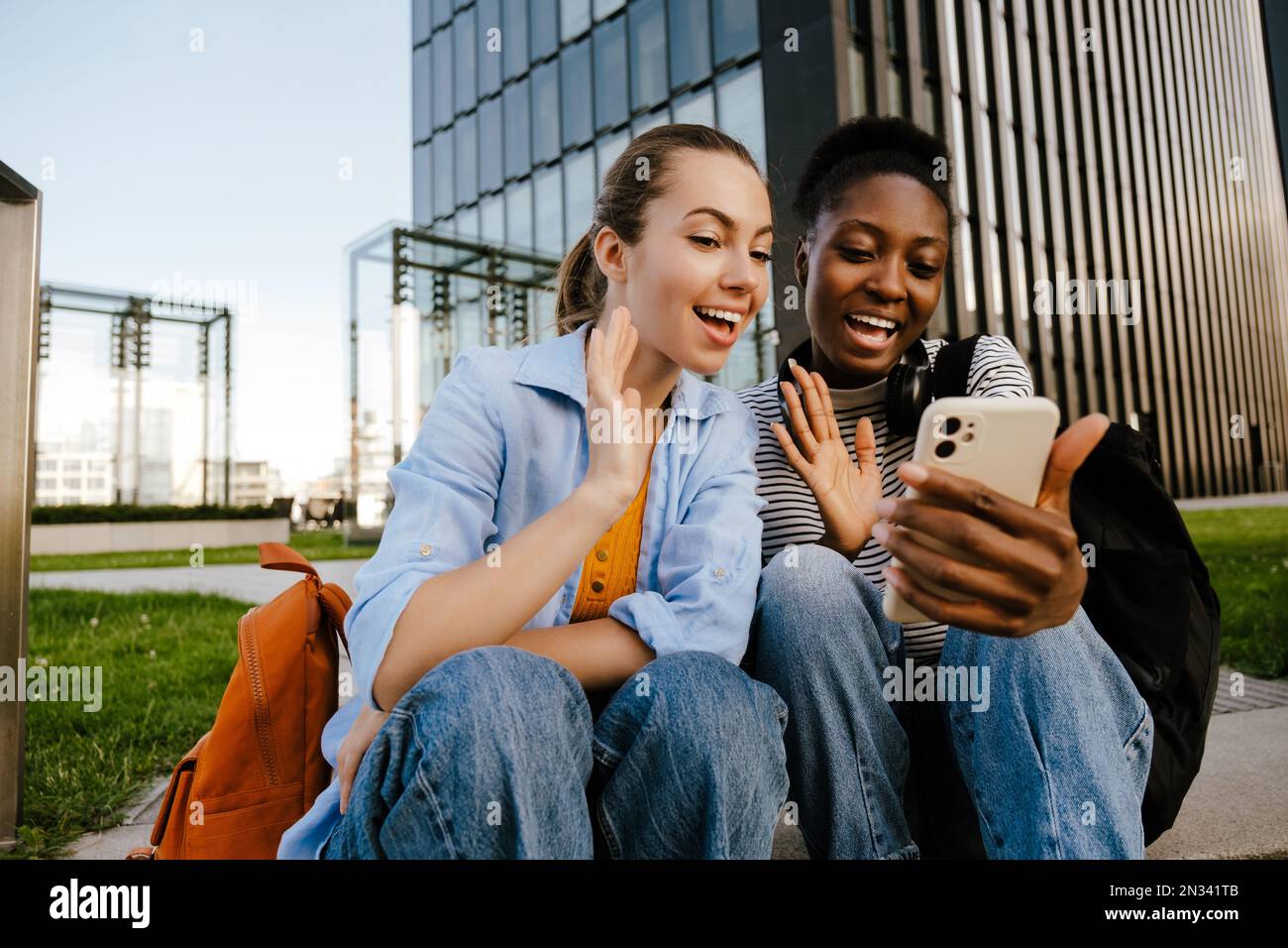 Two woman waving hands friend hi-res stock photography and images - Alamy