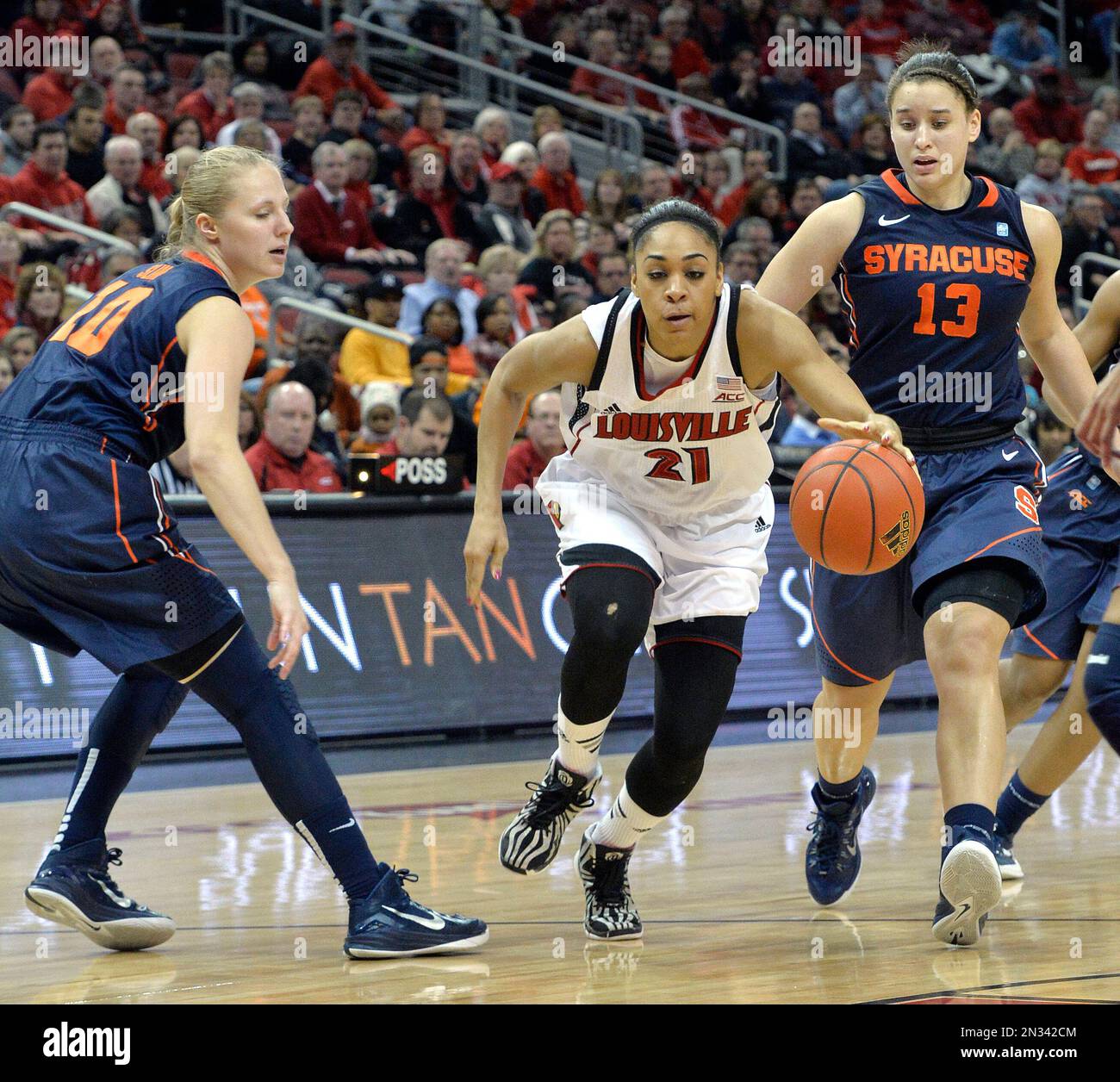 Louisville's Bria Smith, center, splits the defense of Syracuse ...