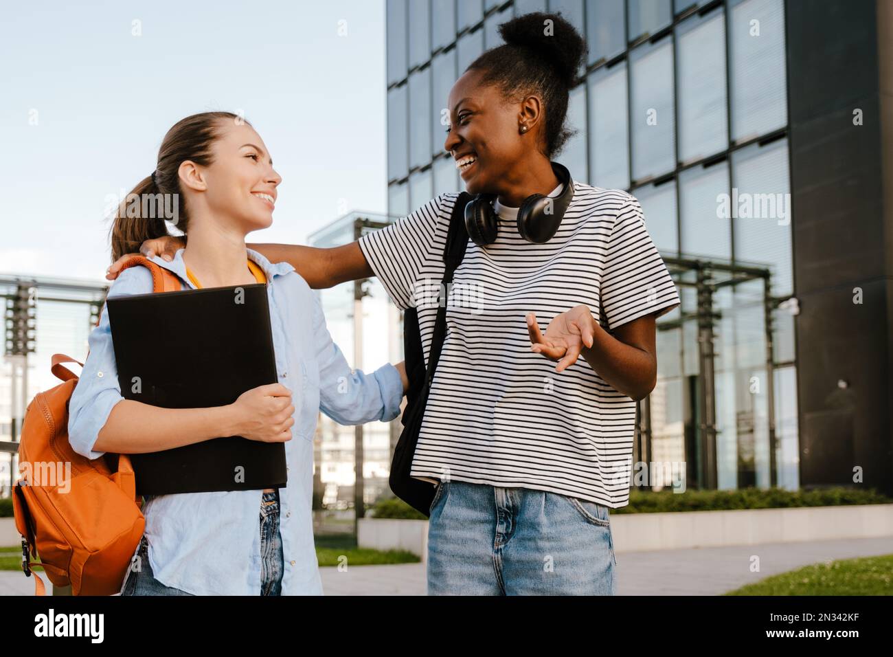 Young multiracial women smiling hi-res stock photography and images - Alamy