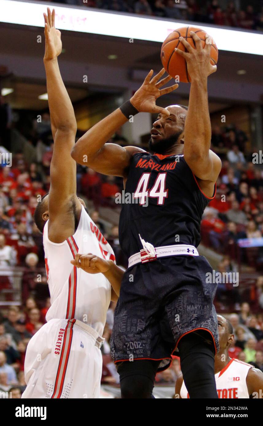 Maryland's Dez Wells, right, goes up for a shot against Ohio State's ...