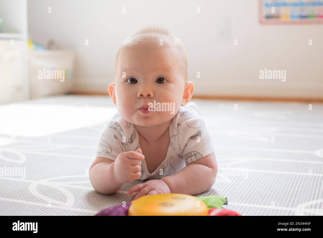 Tummy time of a cute caucasian baby. Playing child. Baby portrait Stock ...
