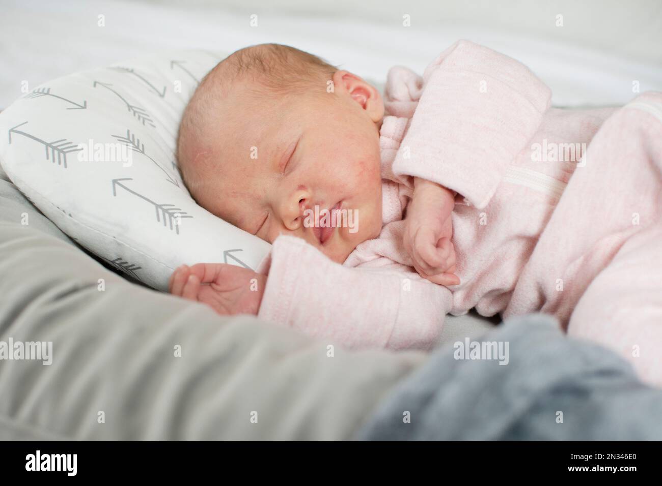 Caucasian Newborn baby sleeping in a baby lounger. Baby nest Stock Photo - Alamy
