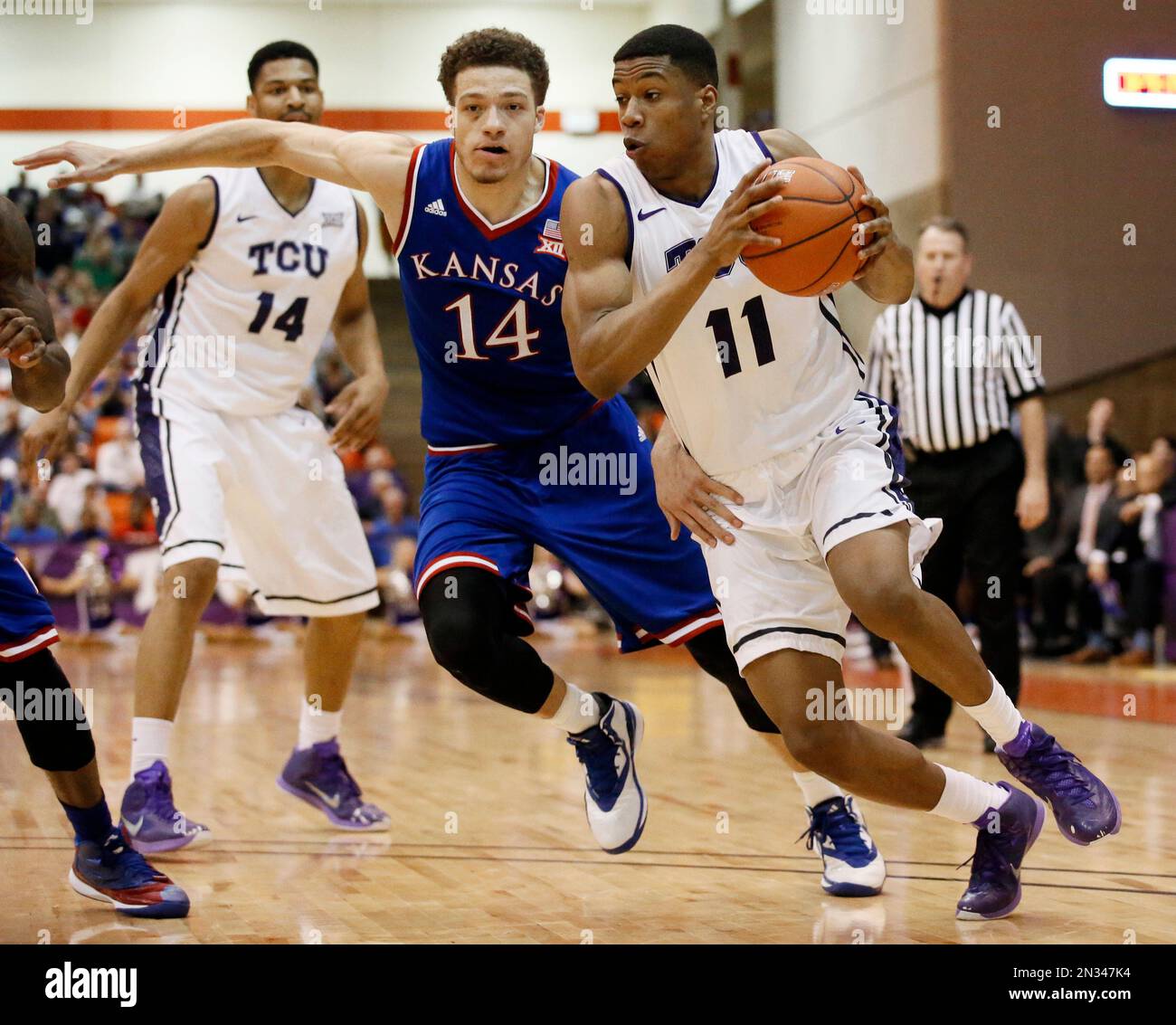 TCU forward Brandon Parrish (11) gets by Kansas' Brannen Greene (14) on ...