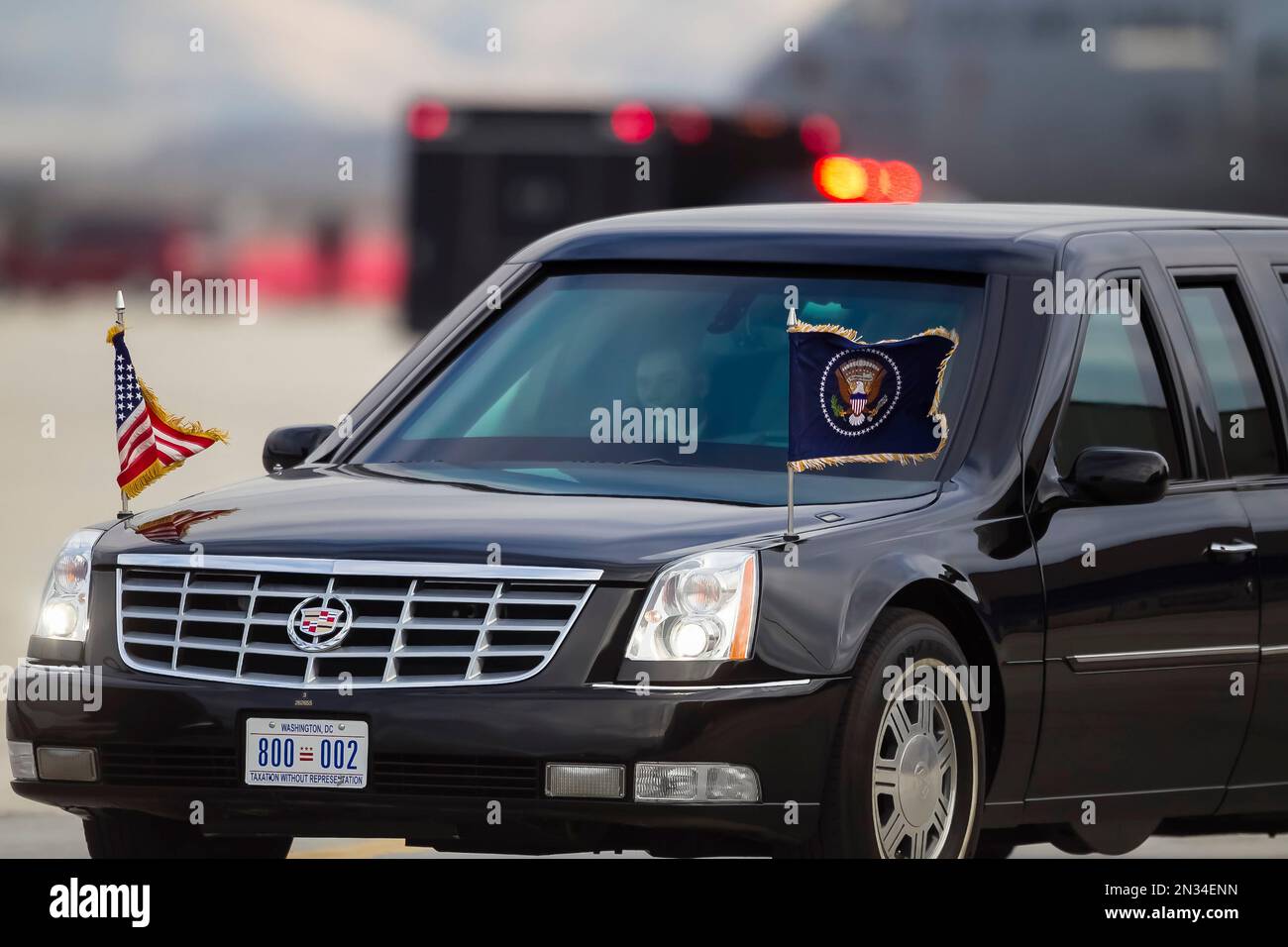 Flags fly on the presidential motorcade as it returns to Gowen Field in ...