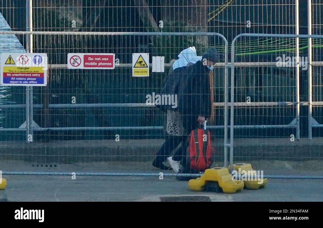 A group of people thought to be migrants walk through the immigration ...