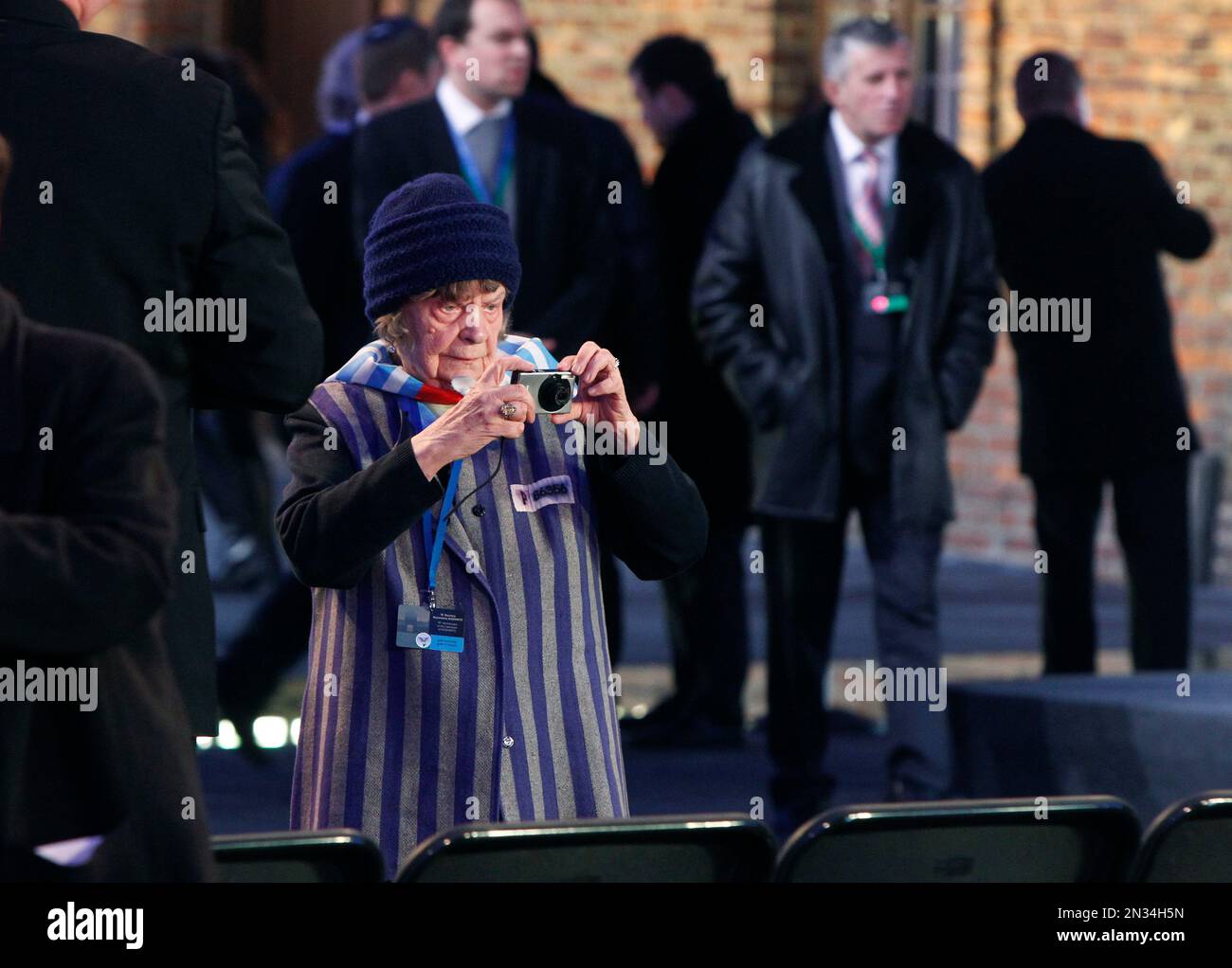A Holocaust survivor takes pictures inside a tent raised at the ...