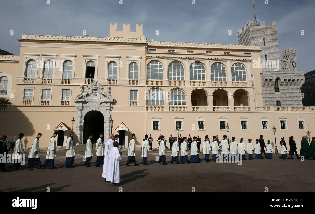 A procession walks past next to Monaco Palace during the St. Devote ...
