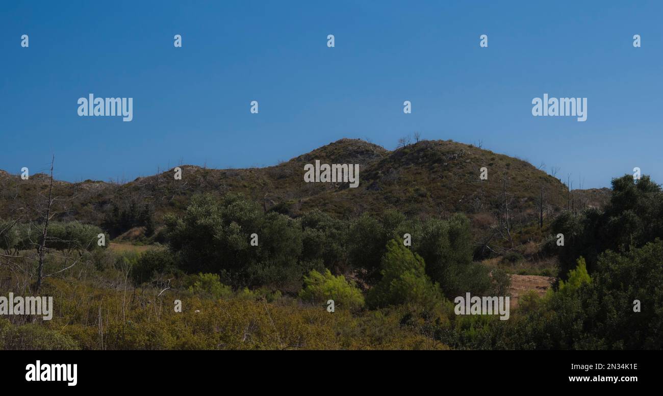 Landscape with small hills at greek island Rhodes Stock Photo - Alamy