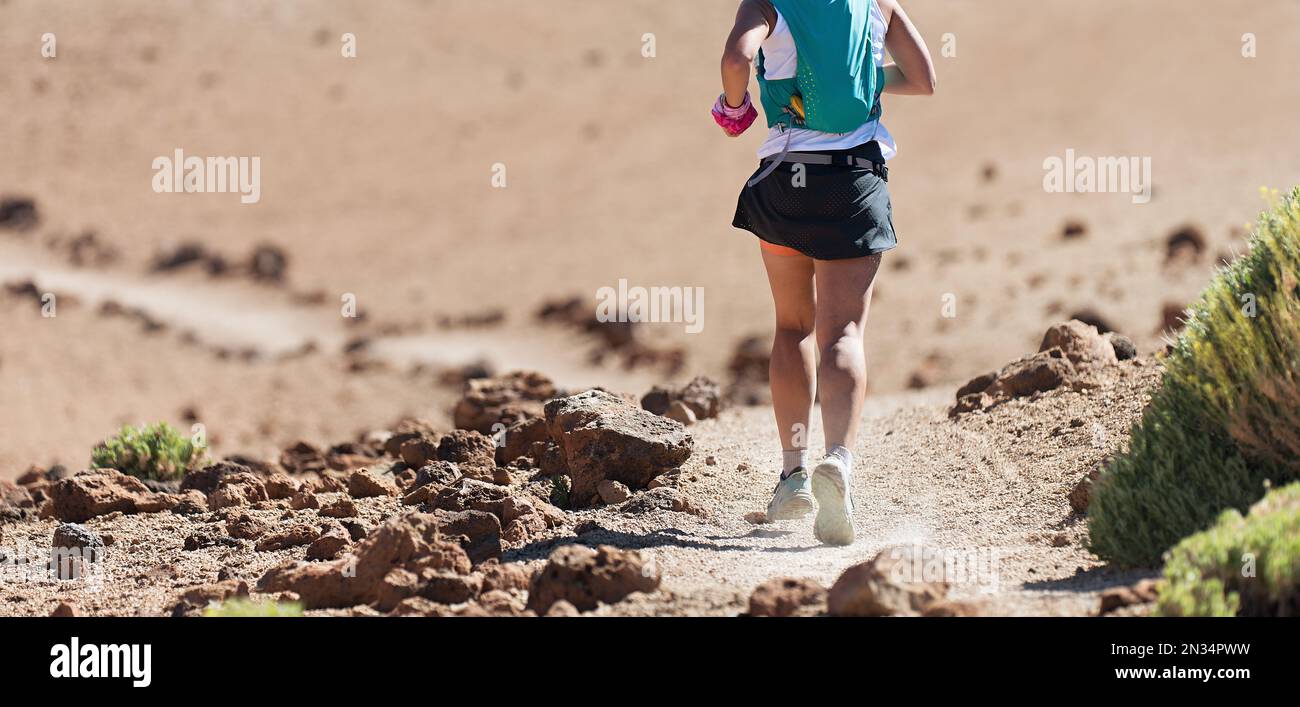 Female athlete run mountain race with hydration trail vest for running ...