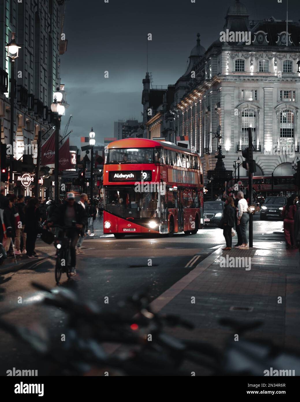 A red Double-decker bus in Moody London street with modern buildings at ...