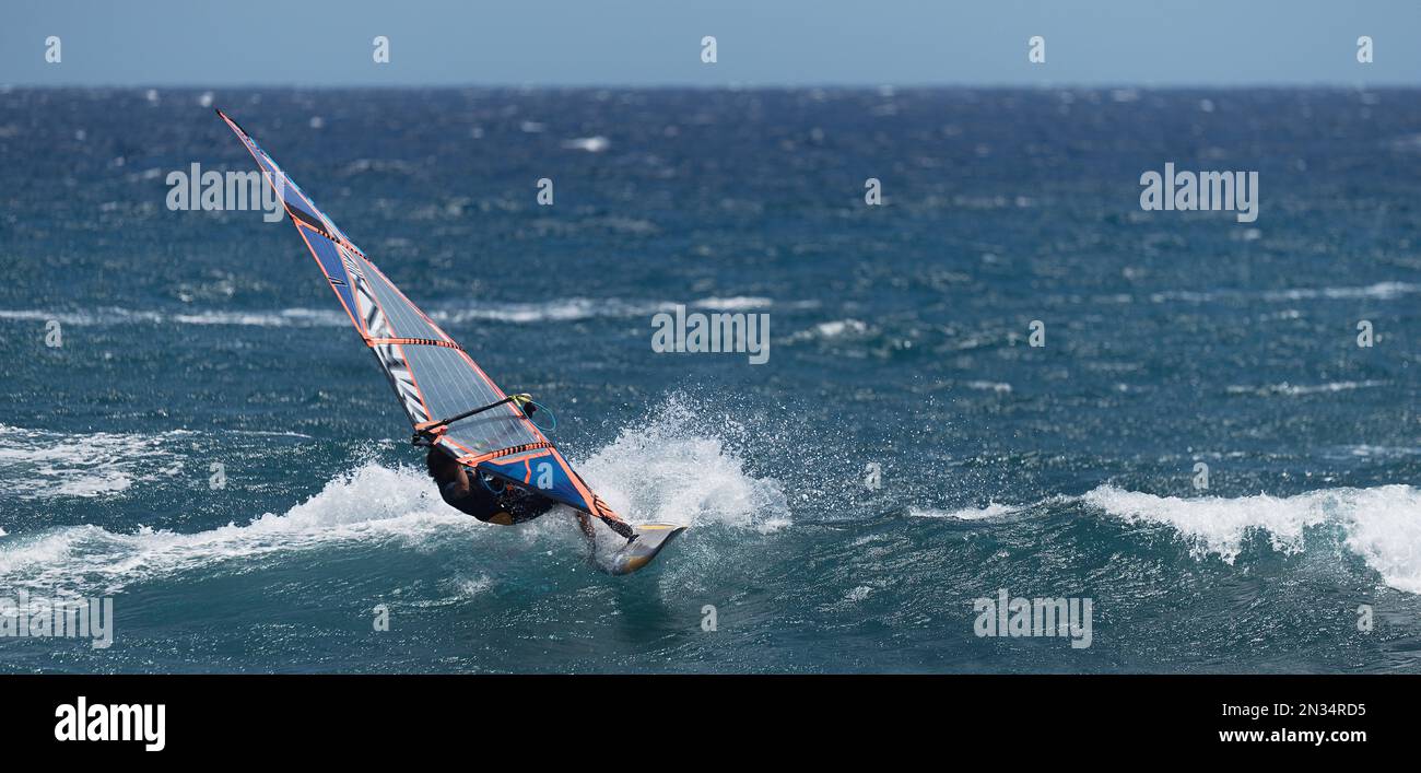 Windsurfer surfing the wind on waves in ocean sea Stock Photo - Alamy