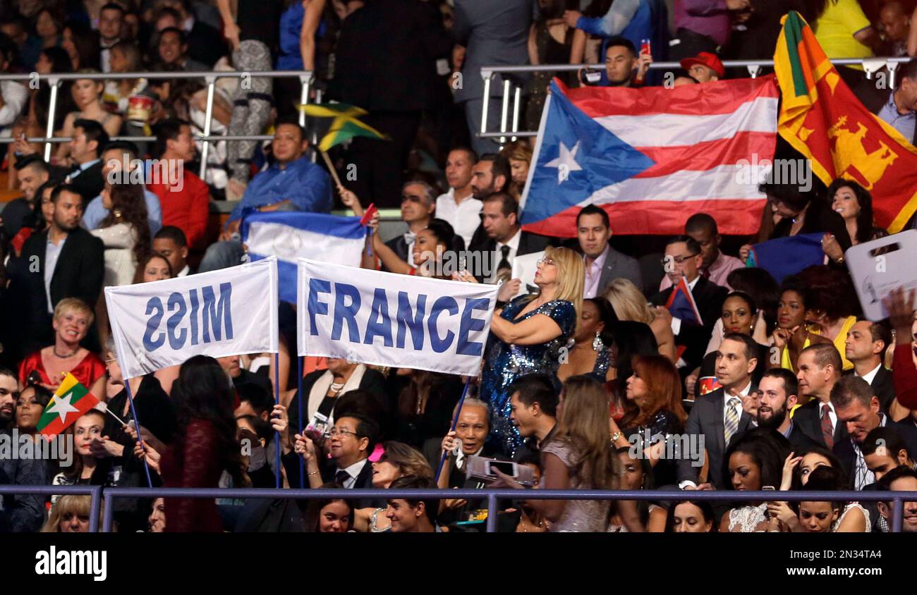 Fans hold up signs and flags of contestants during the Miss Universe ...