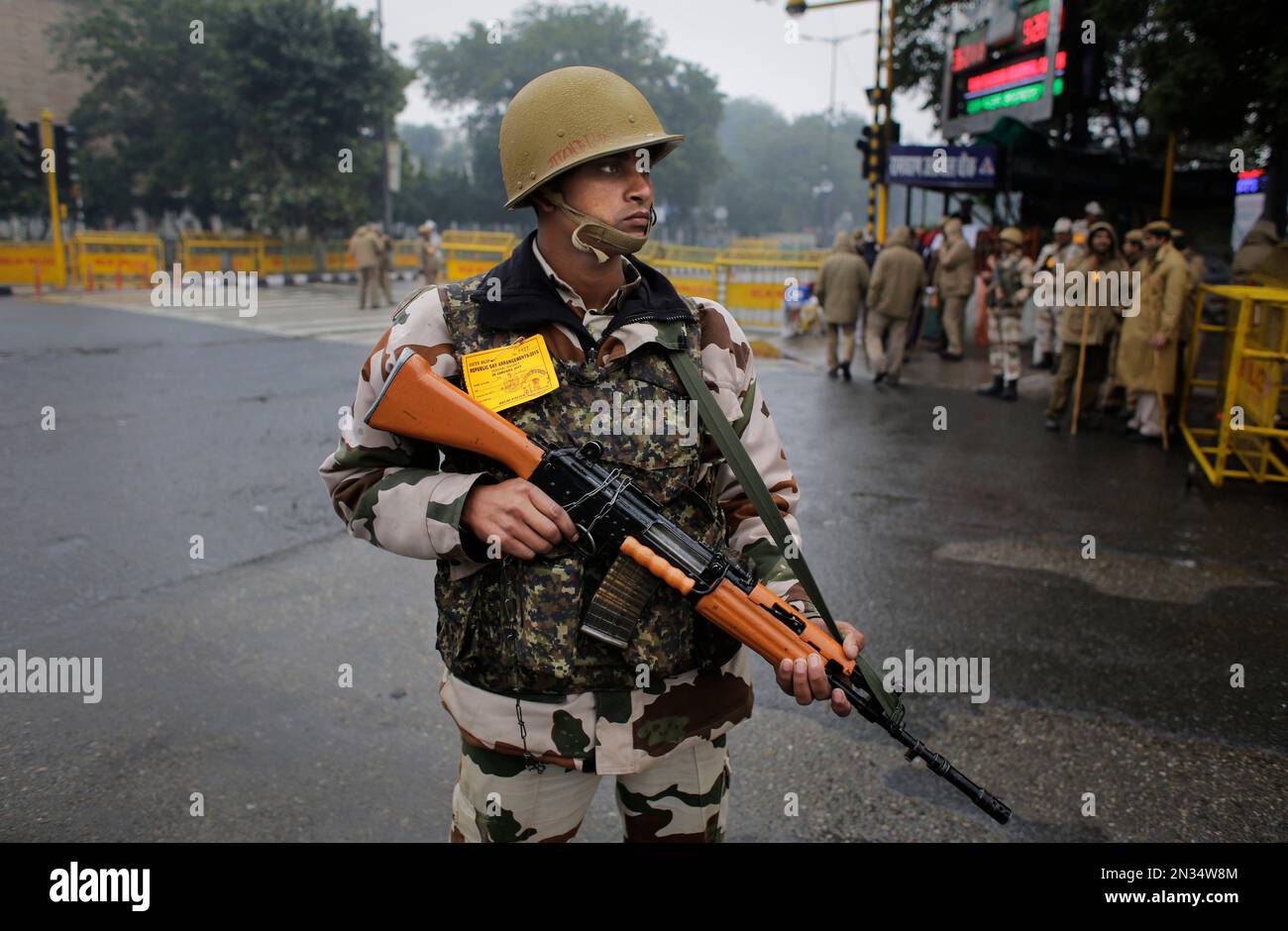 An Indian paramilitary soldier stands guard on a street leading to ...