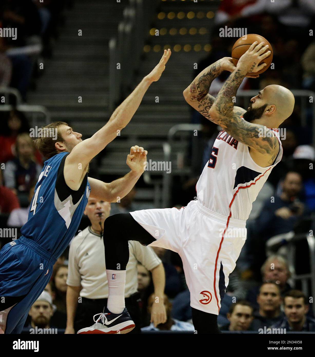 Atlanta Hawks' Pero Antic, right, shoots over Minnesota Timberwolves ...