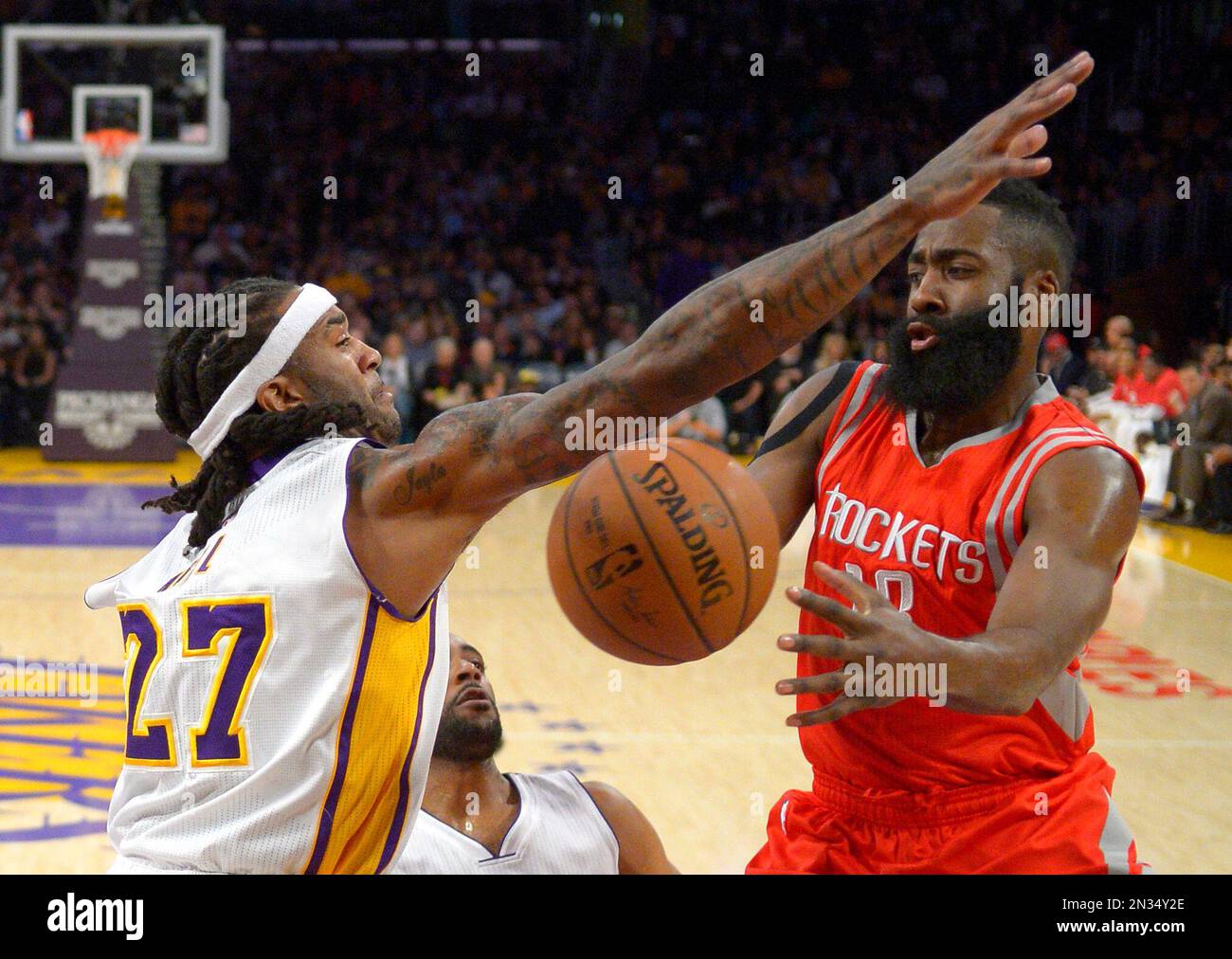 Houston Rockets guard James Harden, right, passes the ball past Los ...