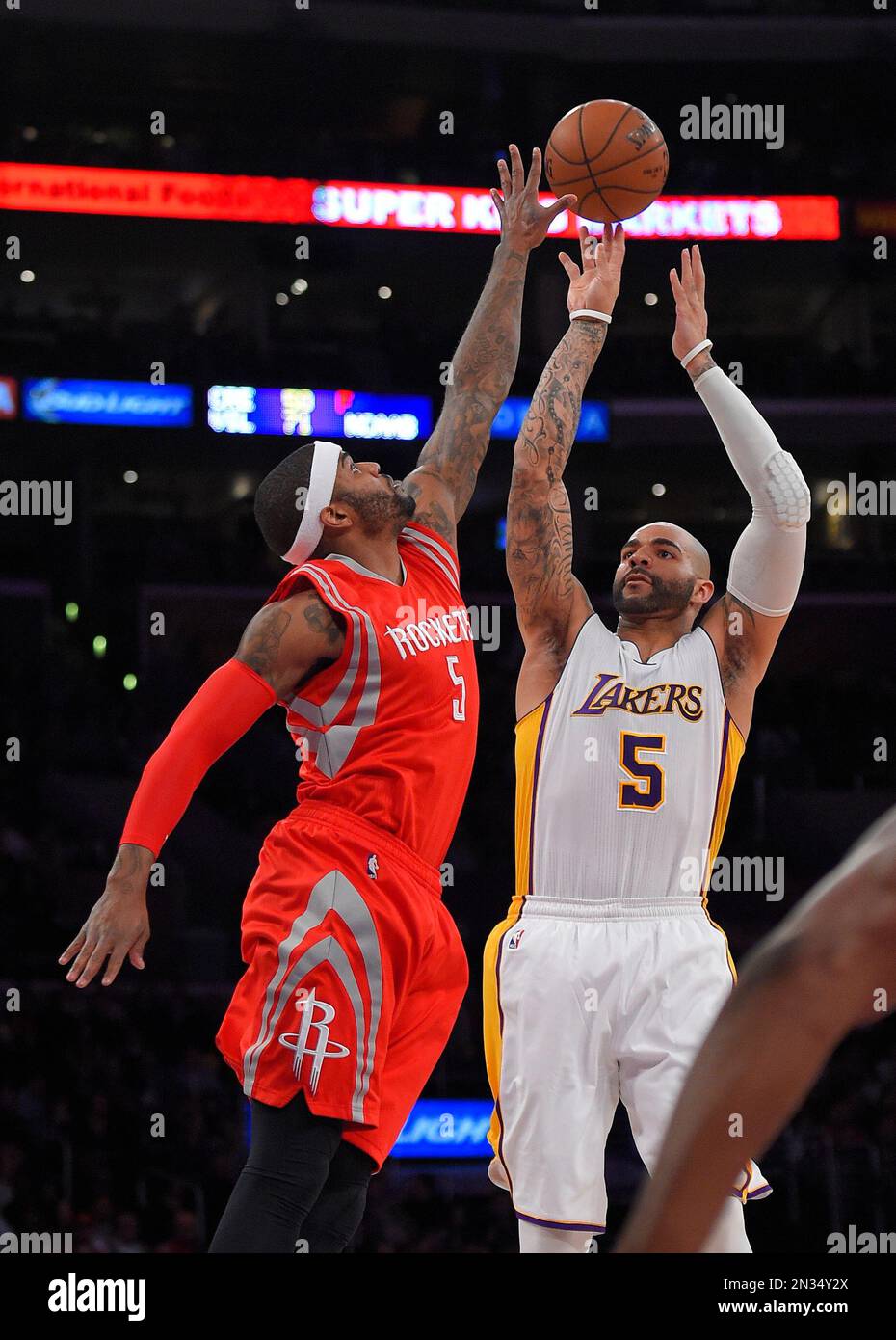 Los Angeles Lakers forward Carlos Boozer, right, shoots as Houston ...