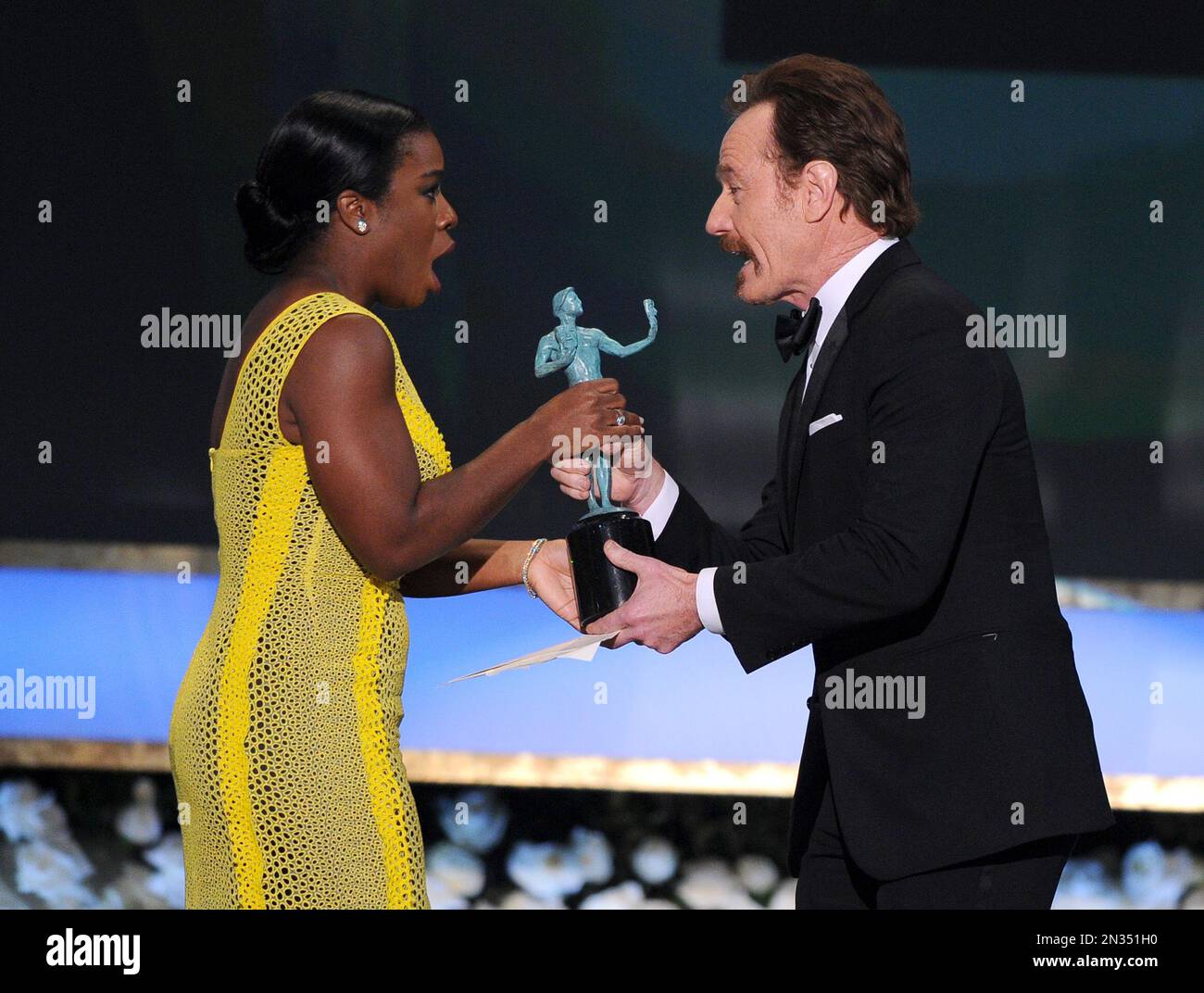 Bryan Cranston, left, presents Uzo Aduba with the award for outstanding ...