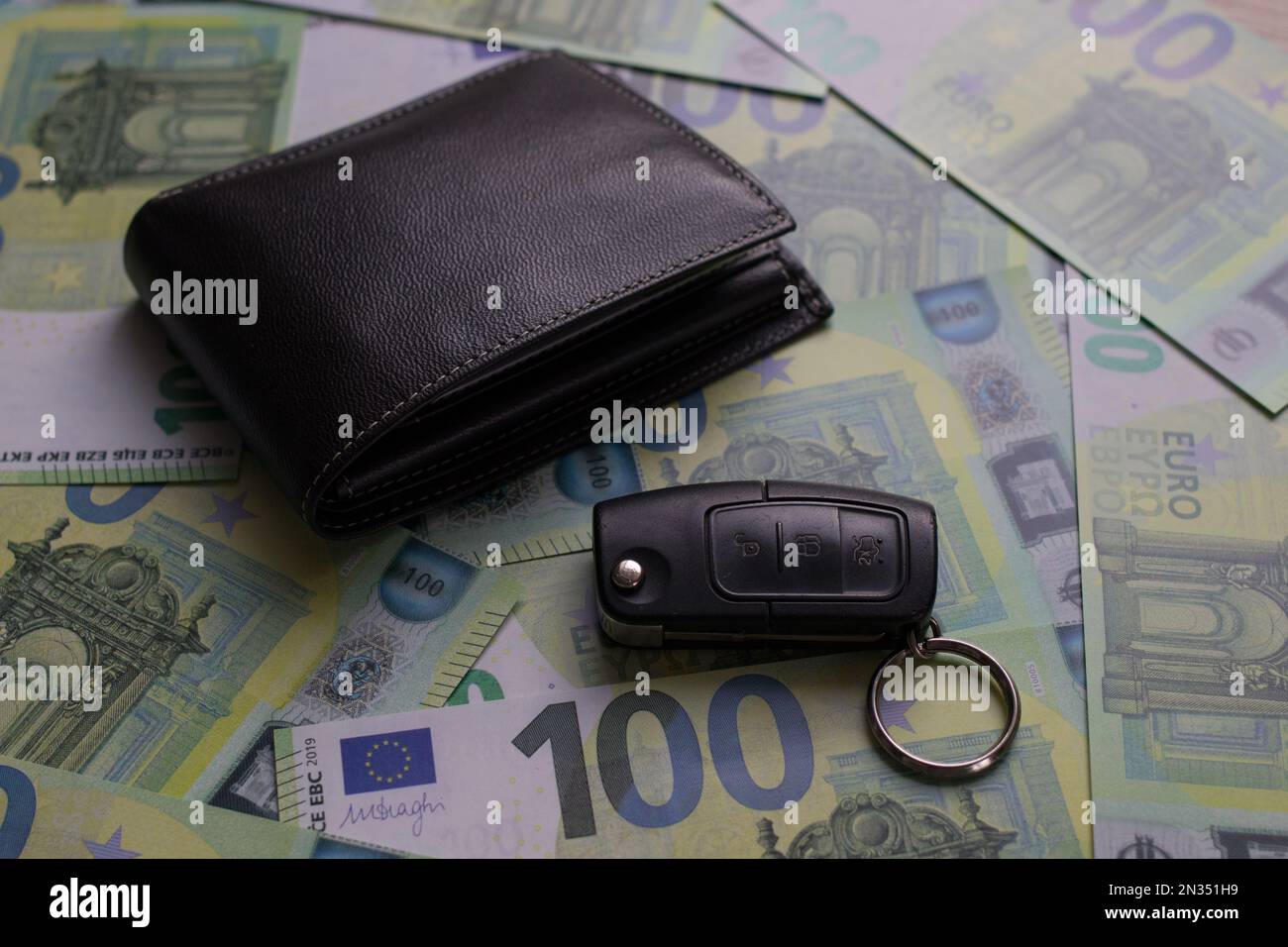 black wallet and car key is on 100 euro banknotes Stock Photo - Alamy