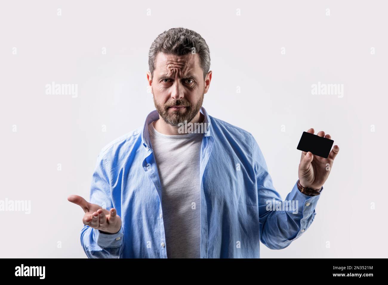 shrugging guy holding business debit. photo of guy hold business debit ...