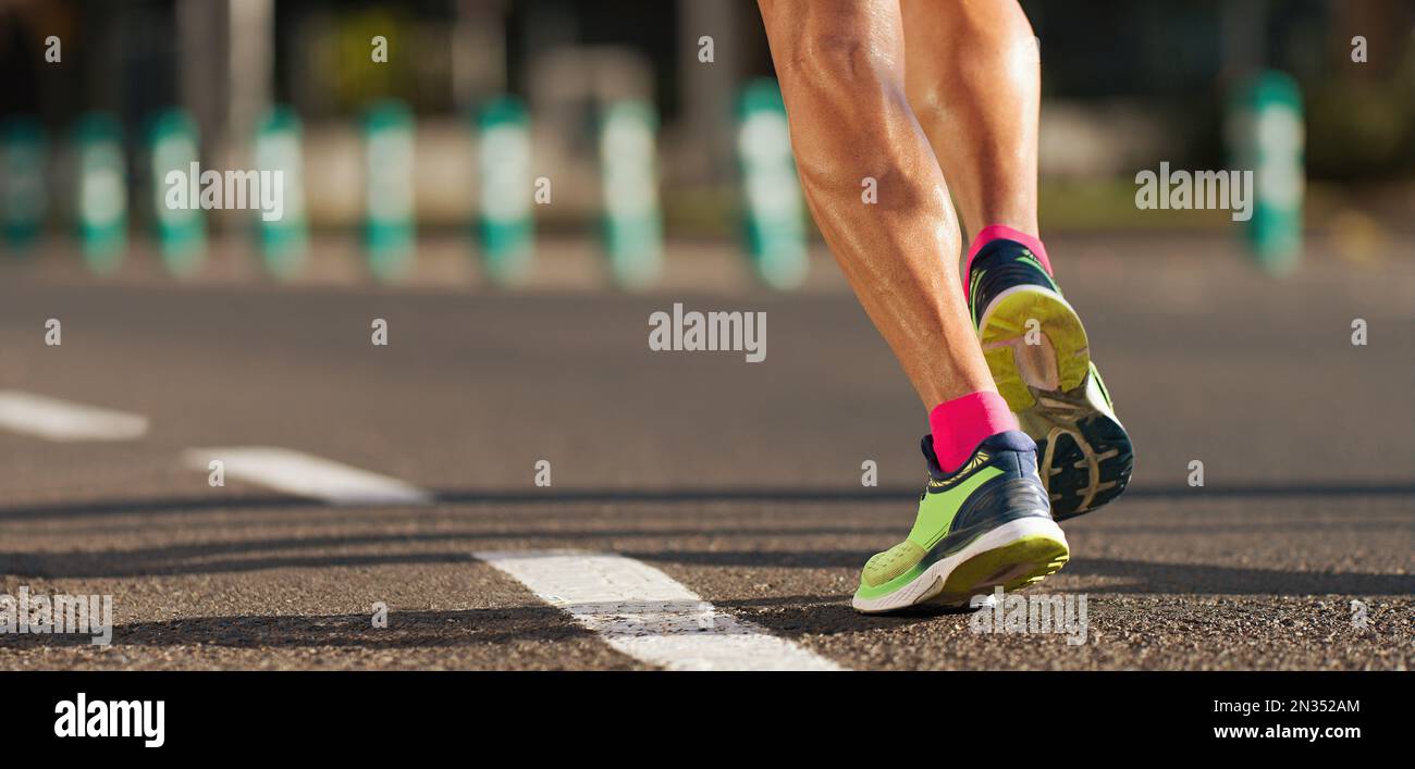 Athlete runner feet running on road close up on shoe, marathon running ...