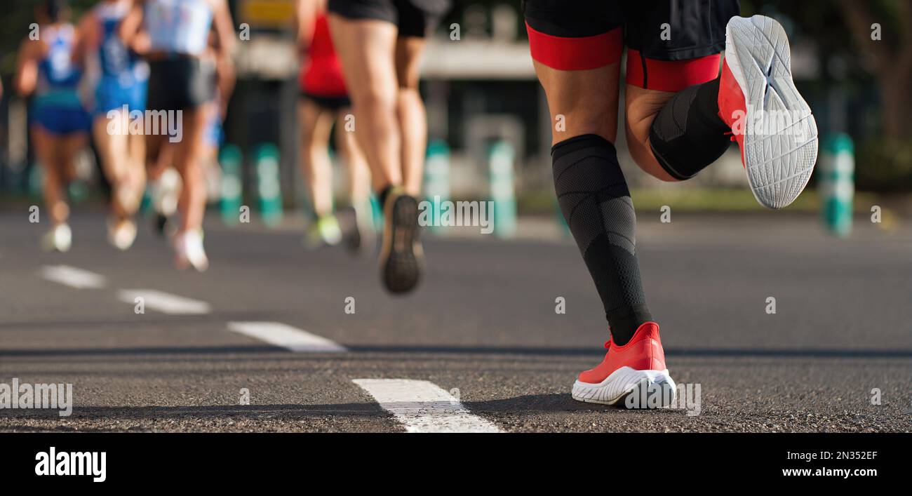 Marathon running race, people feet on city road Stock Photo - Alamy
