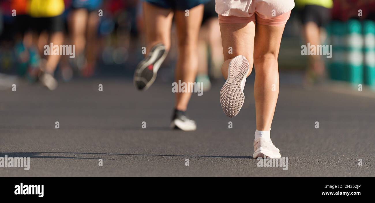 Marathon running race, people feet on city road Stock Photo - Alamy