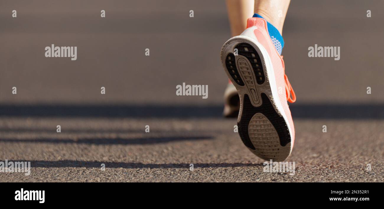 Athlete runner feet running on road close up on shoe, marathon running ...