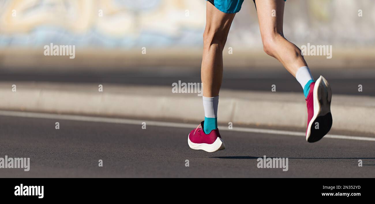Athlete runner feet running on road close up on shoe, marathon running ...
