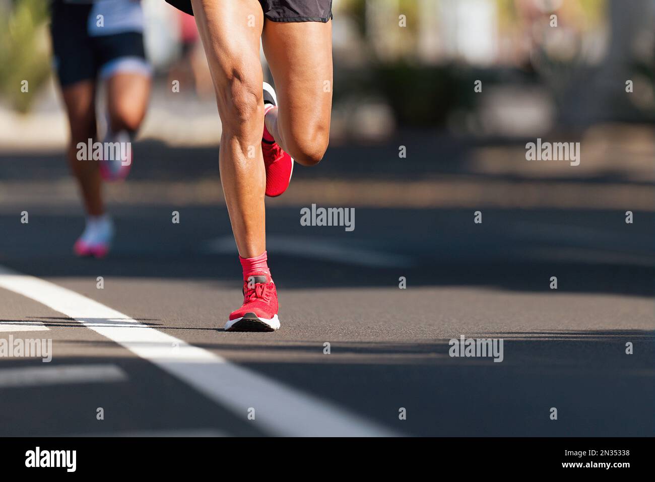 Marathon running race, people feet on city road Stock Photo - Alamy