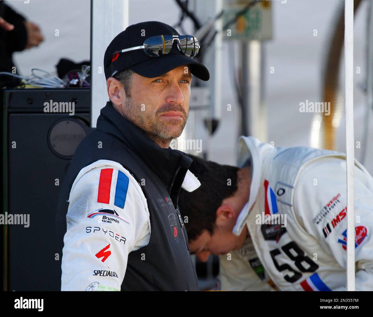 Driver Patrick Dempsey looks out on the track from his pit stall during ...