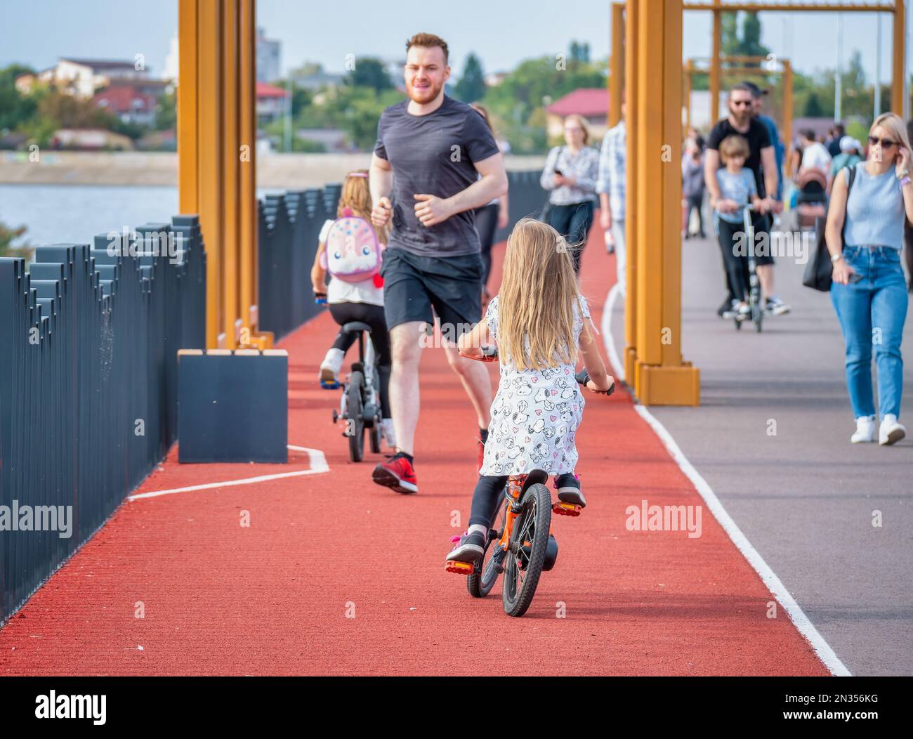 Crowds of people and families strolling on a weekend on the promenade ...