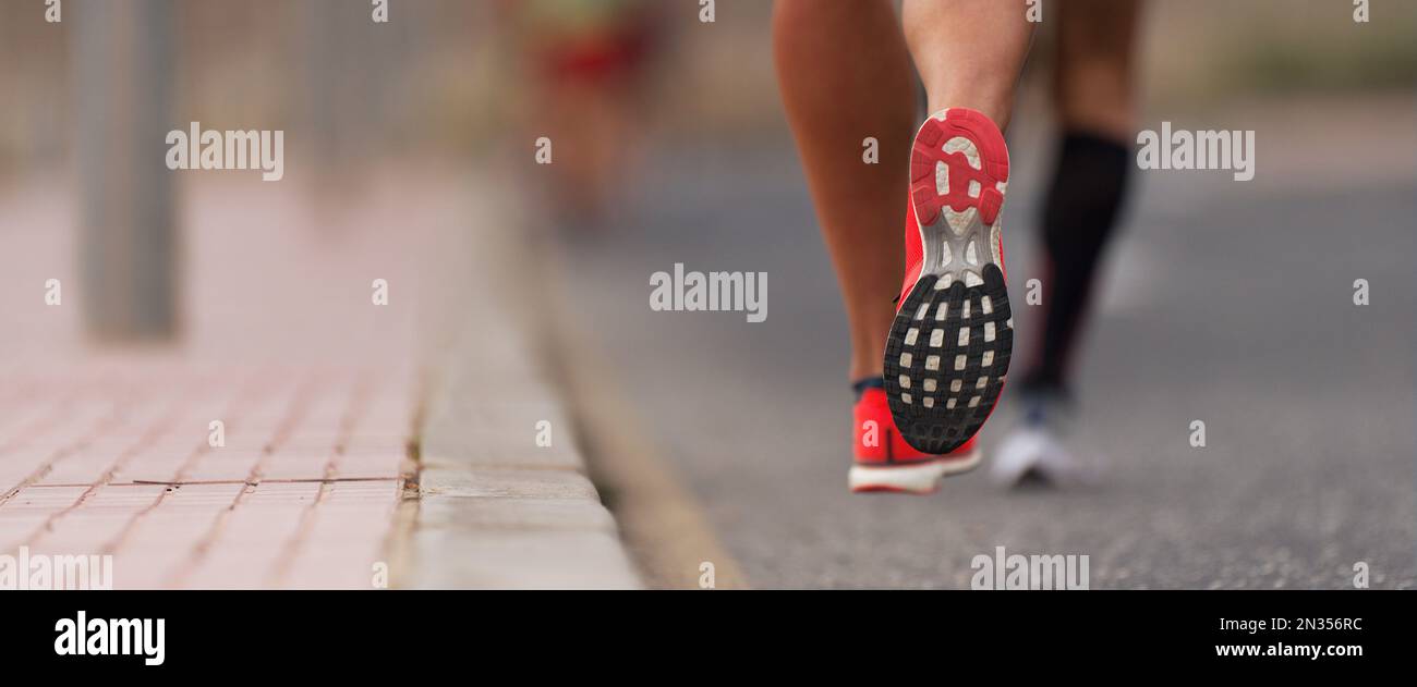 Marathon running race, people feet on city road, runners run urban ...