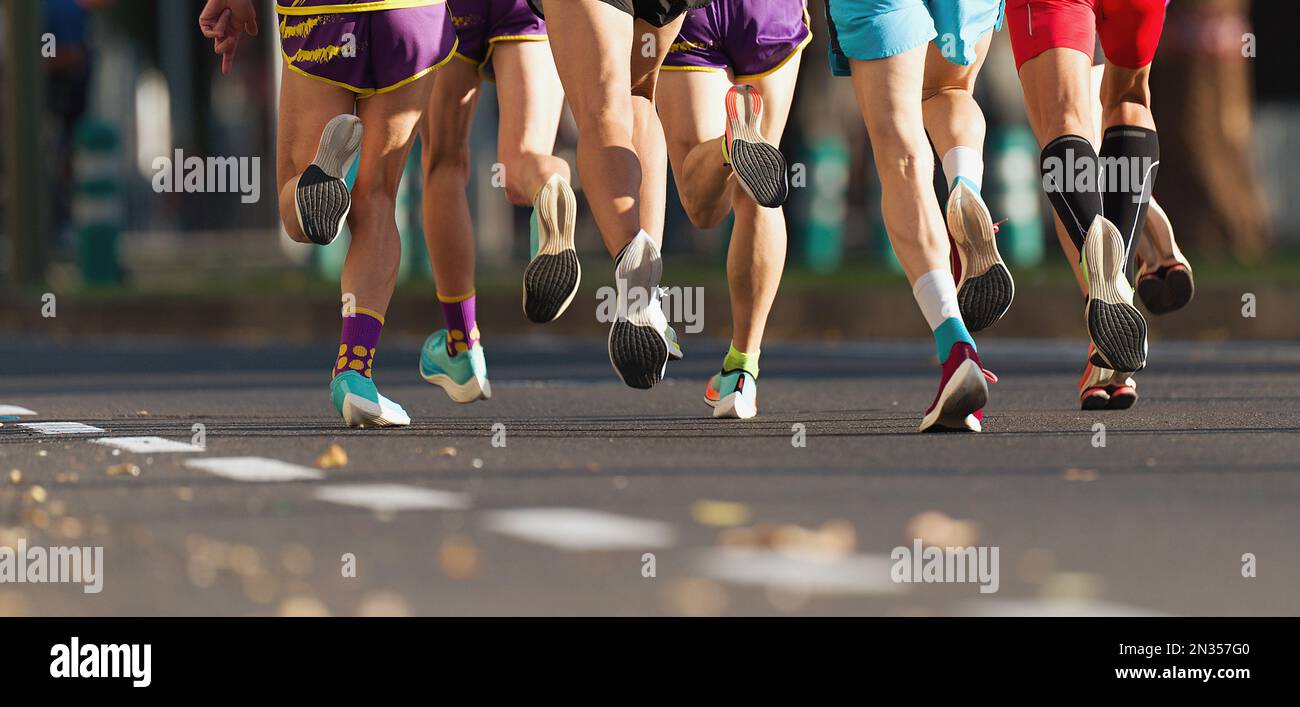 Marathon runners running on city road, large group of runners Stock ...