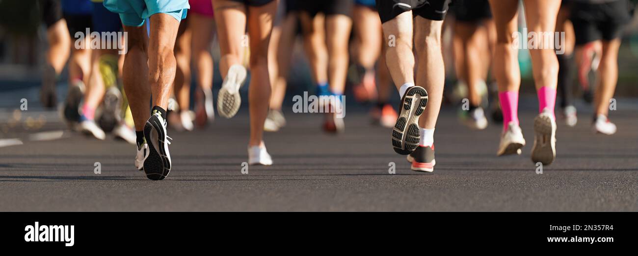 Marathon runners running on city road, large group of runners Stock ...