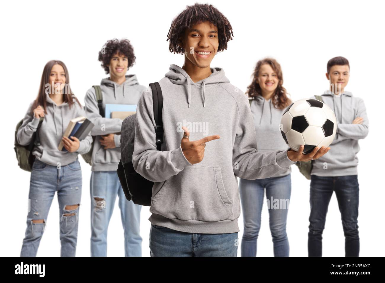 African american male student holding a football and other students ...