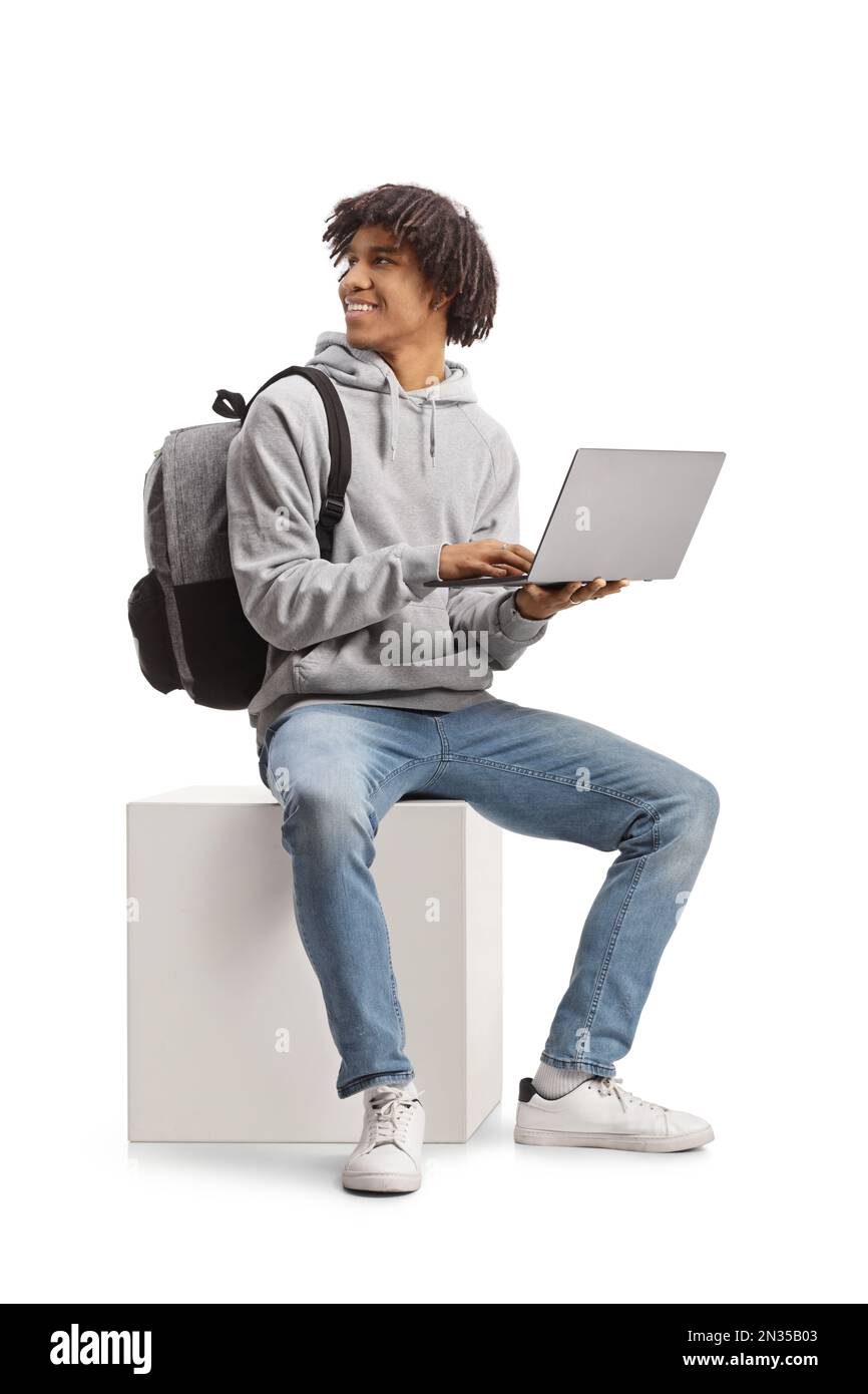 Male african american student sitting with a laptop computer and ...