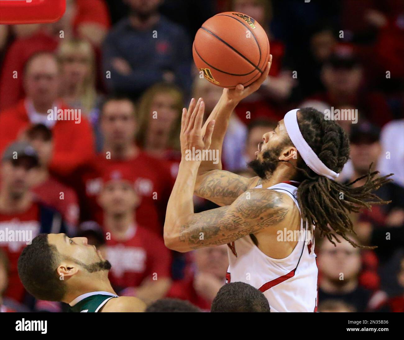 Nebraska's Terran Petteway, right, shoots over Michigan State's Denzel ...