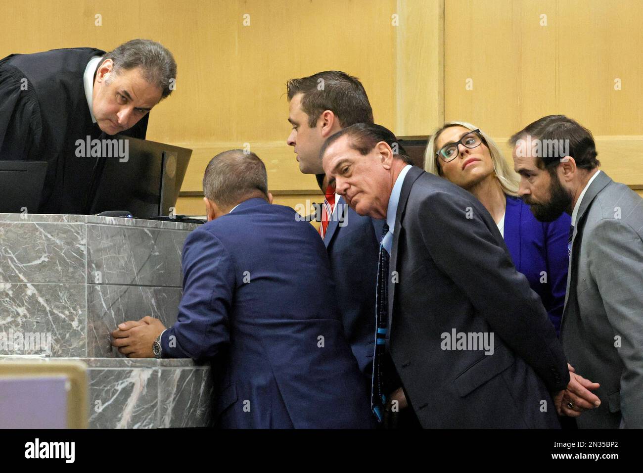 Judge Michael Usan speaks with attorneys just before opening statements ...