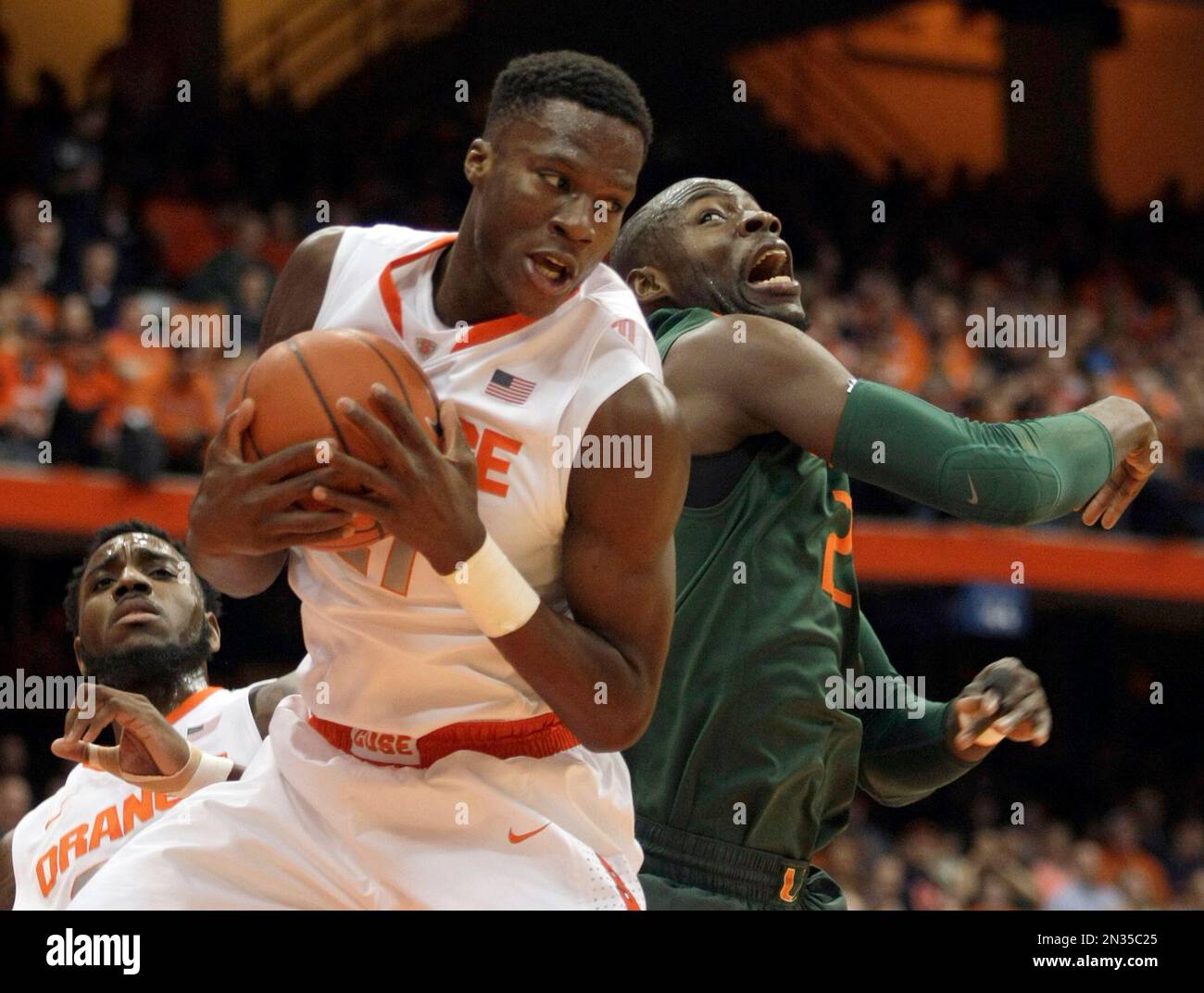 Syracuse’s Tyler Roberson, left, grabs a rebound from Miami’s Tonje ...