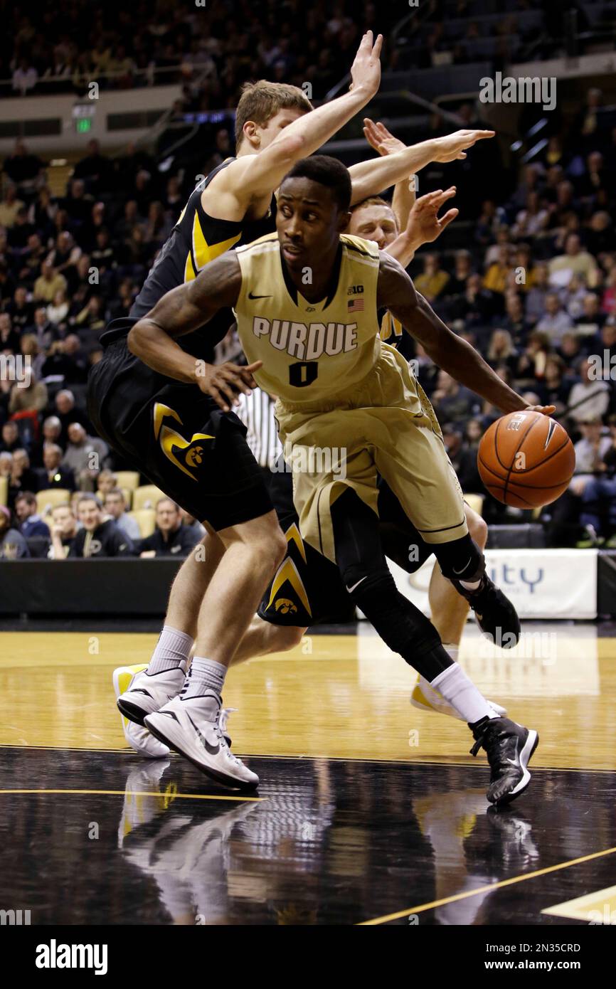 Purdue guard Jon Octeus (0) drives around Iowa forward Jarrod Uthoff ...